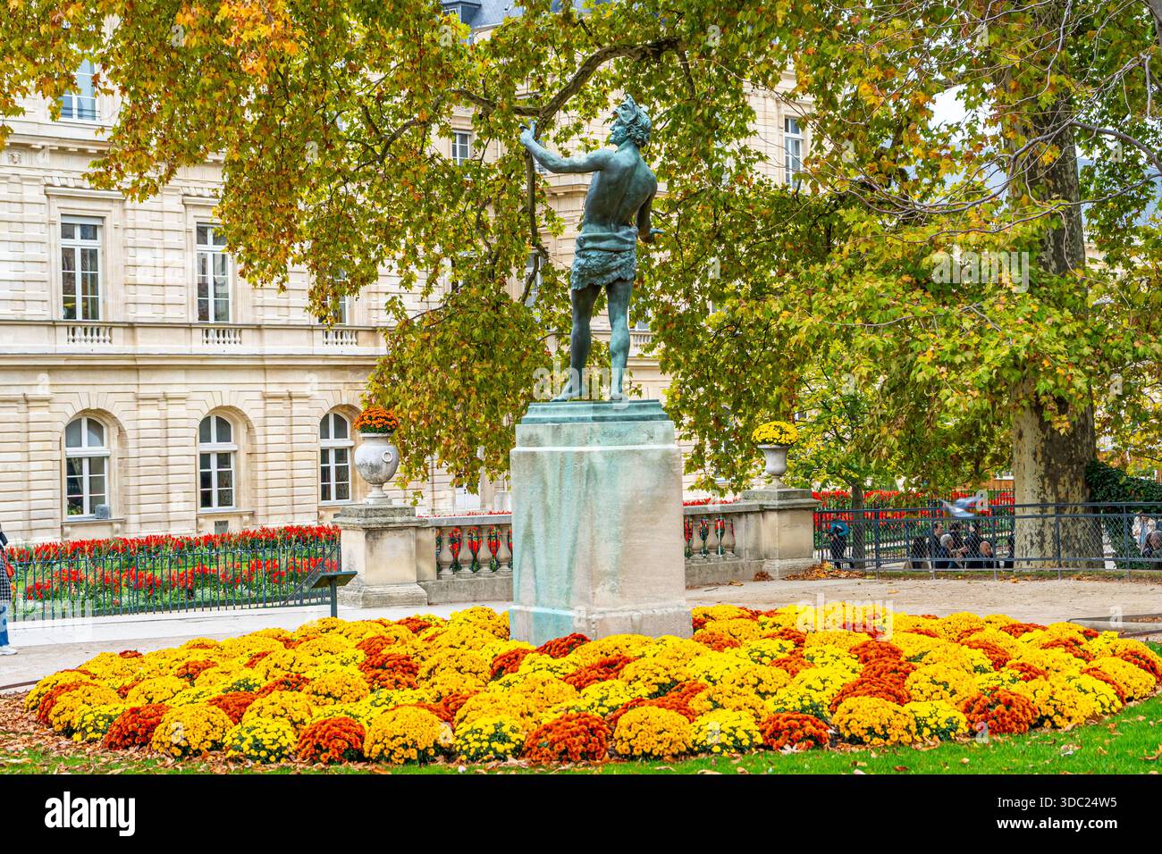Paris, France - October 30, 2025: Autumn in park trees. Bronze statue ...