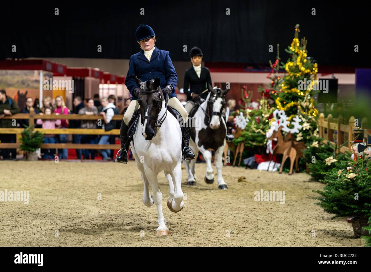Riders riding on horses at the London International Horse Show on ...