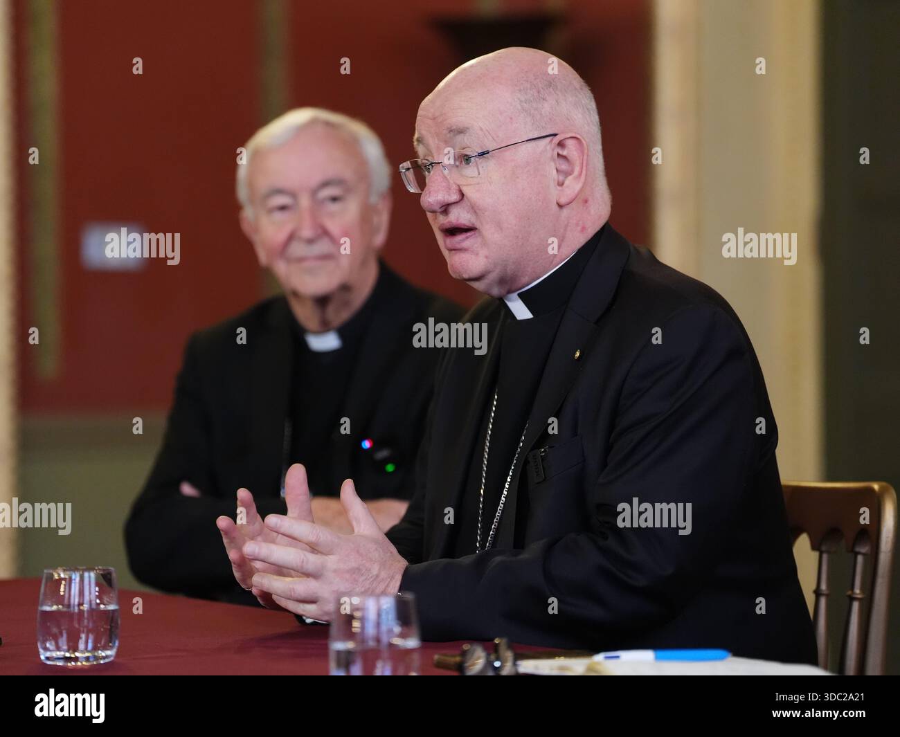 Outgoing archbishop of Westminster Vincent Nichols (left) listening to ...