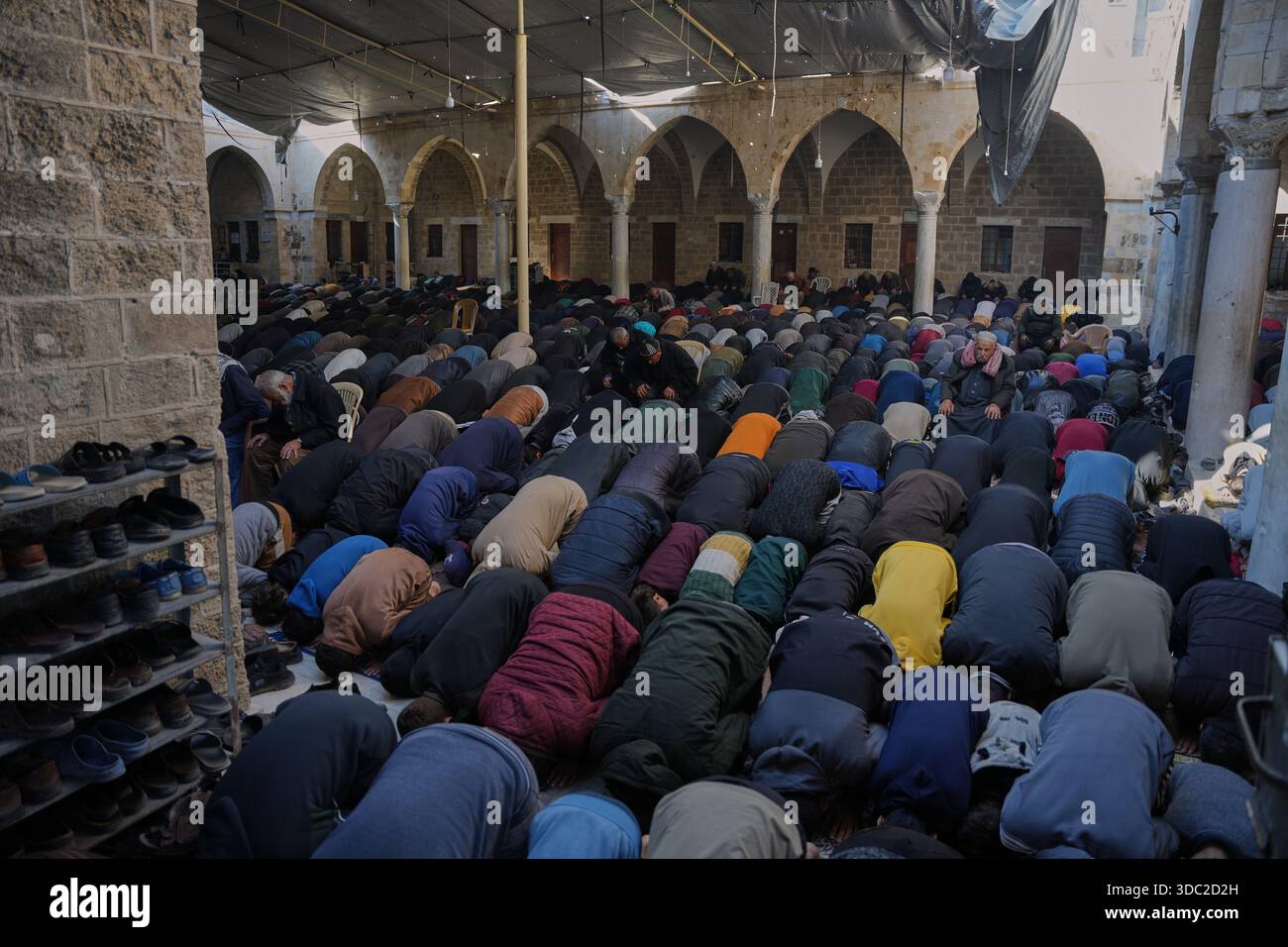 Palestinians attend Friday prayers at the Sayyid Hashim Mosque, in Gaza ...