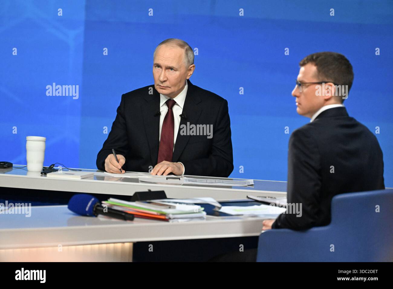 Russian President Vladimir Putin (left) and VGTRK political commentator ...