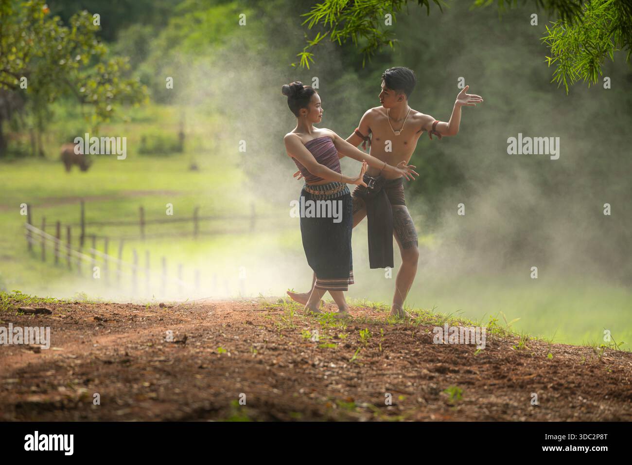 A farmer and a rice worship ritual with a group of traditional dancers ...