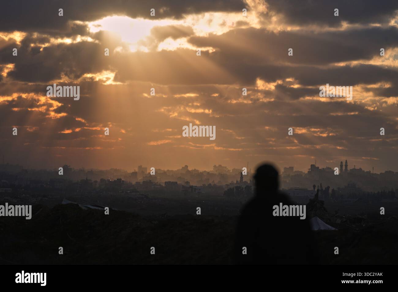 A Palestinian looks over an area of buildings destroyed during Israeli ...
