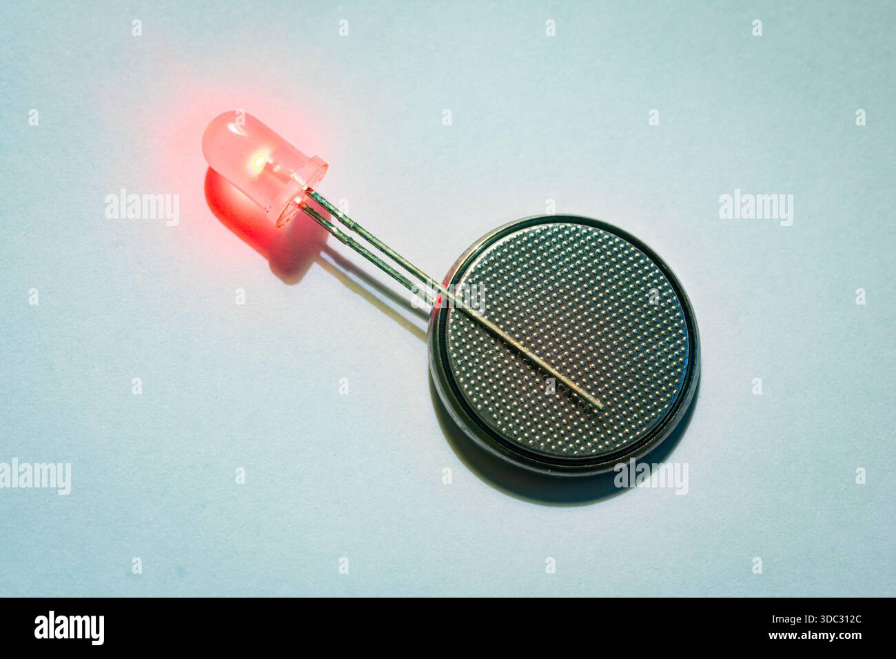 Small battery with a lit red LED, science and education concept Stock ...