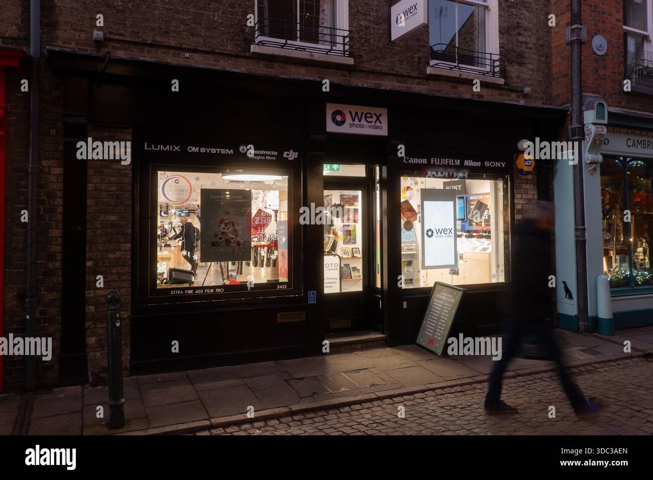 Cambridge, UK, 19 December, 2025. Festive shoppers outside WEX Photo in ...