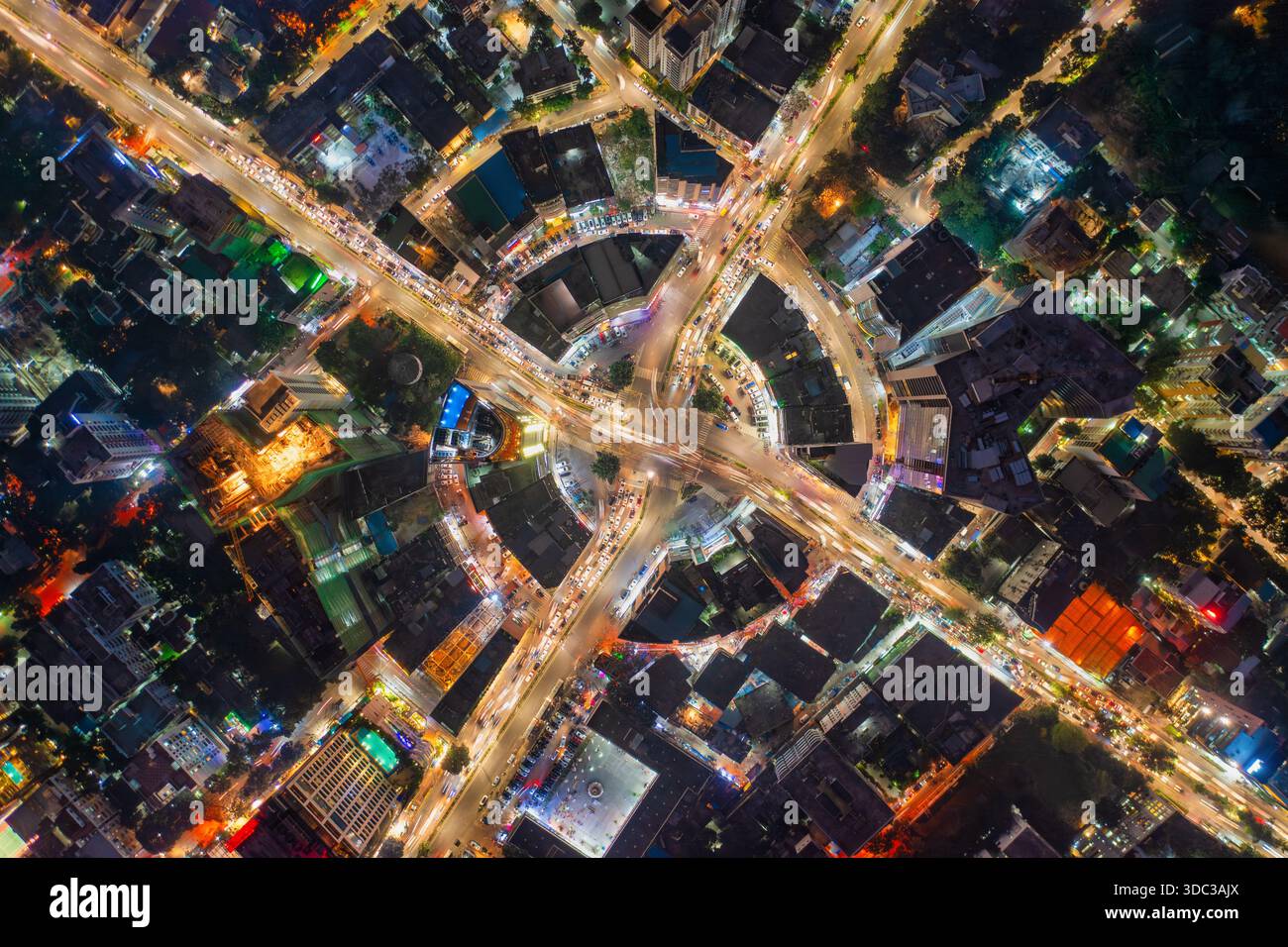 Aerial view of circular roads and bridges illuminated with lights in ...