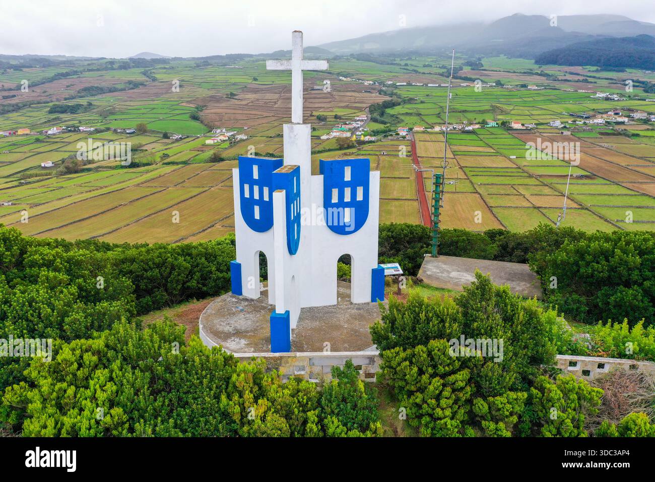 Aerial view of the stark white and blue monument with a cross piercing ...