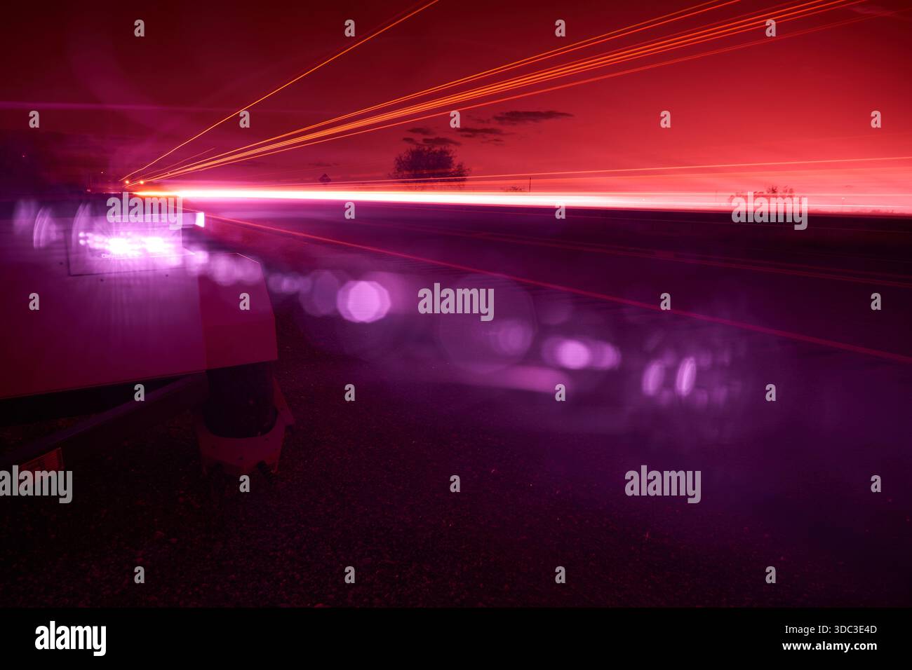 An infrared beam of light shines out of an automatic license plate ...