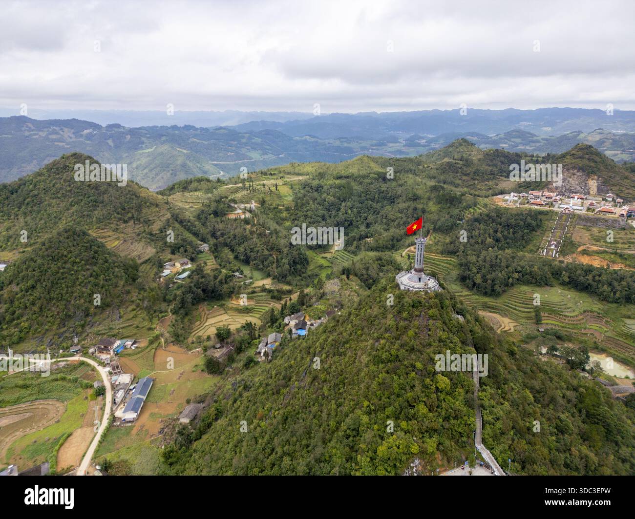 Aerial view of the vibrant red flag atop Lung Cu Flag Tower amidst ...