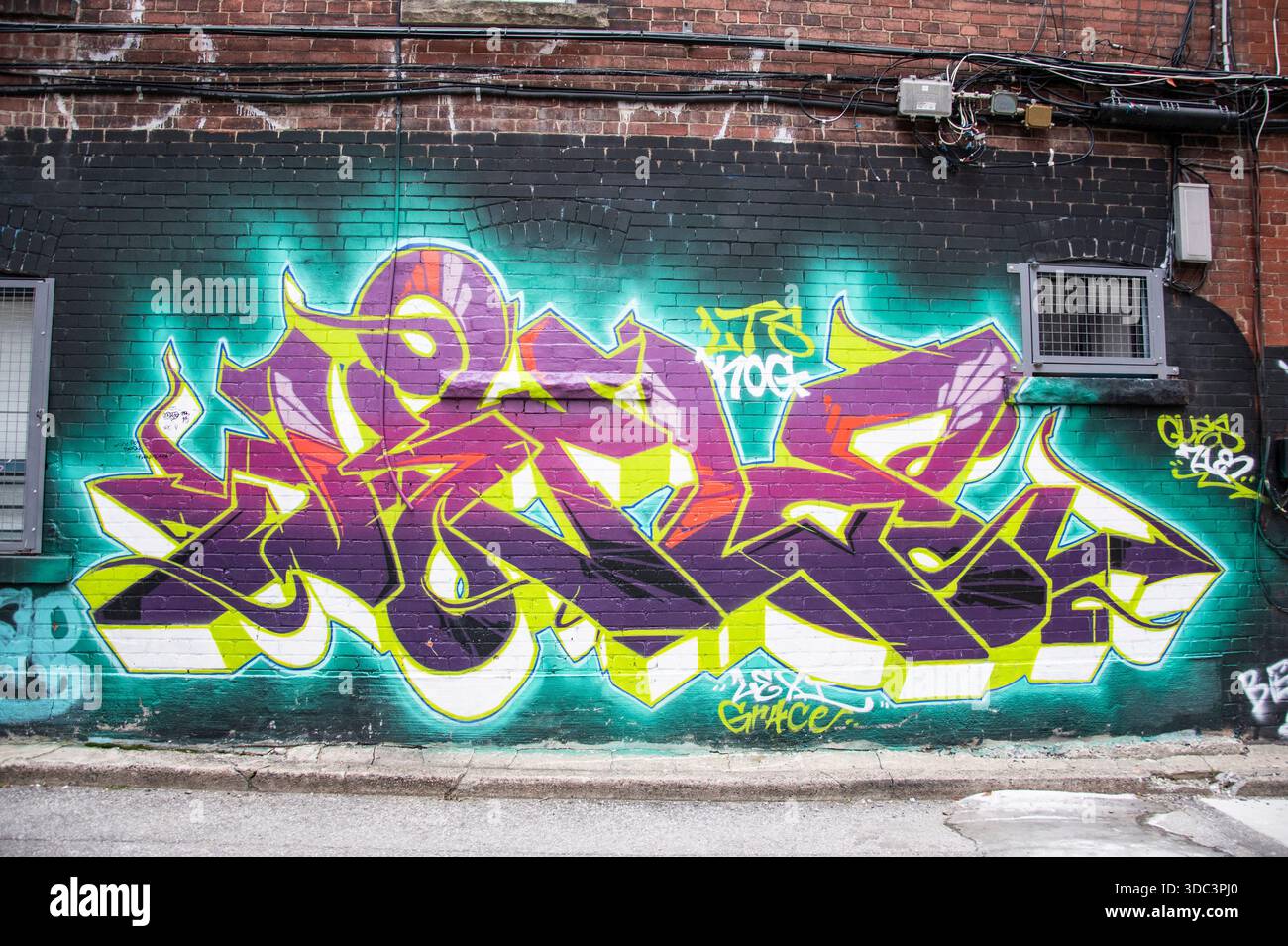 Graffiti tagged at Graffiti Alley fashion district in downtown Toronto ...