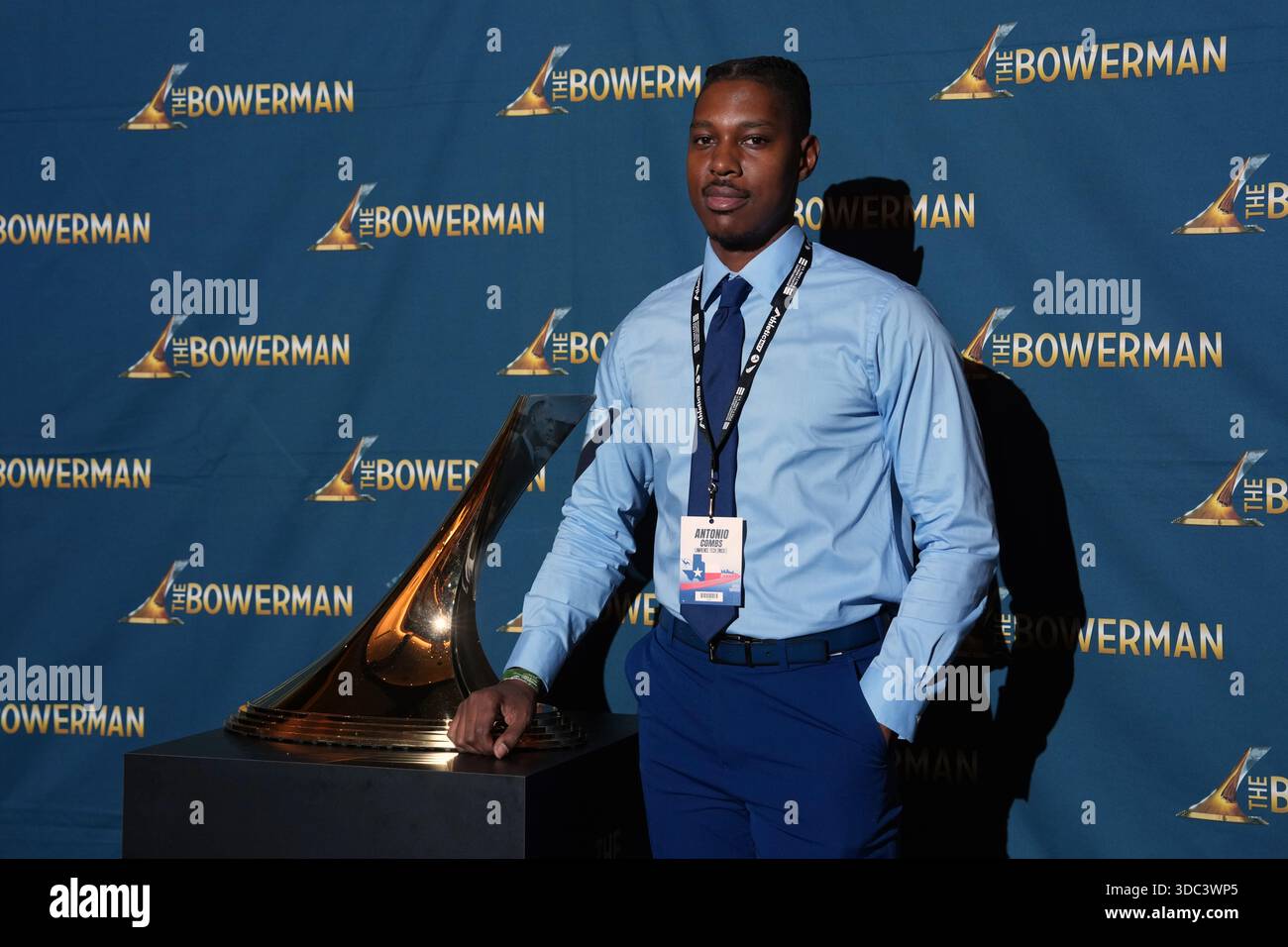Lawrence Tech jumps coach Antonio Combs poses with the Bowerman Award ...