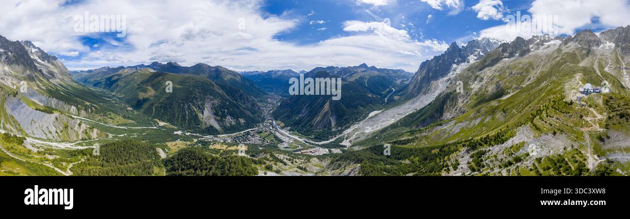 Wide aerial panorama of a dramatic mountain valley with steep rocky ...