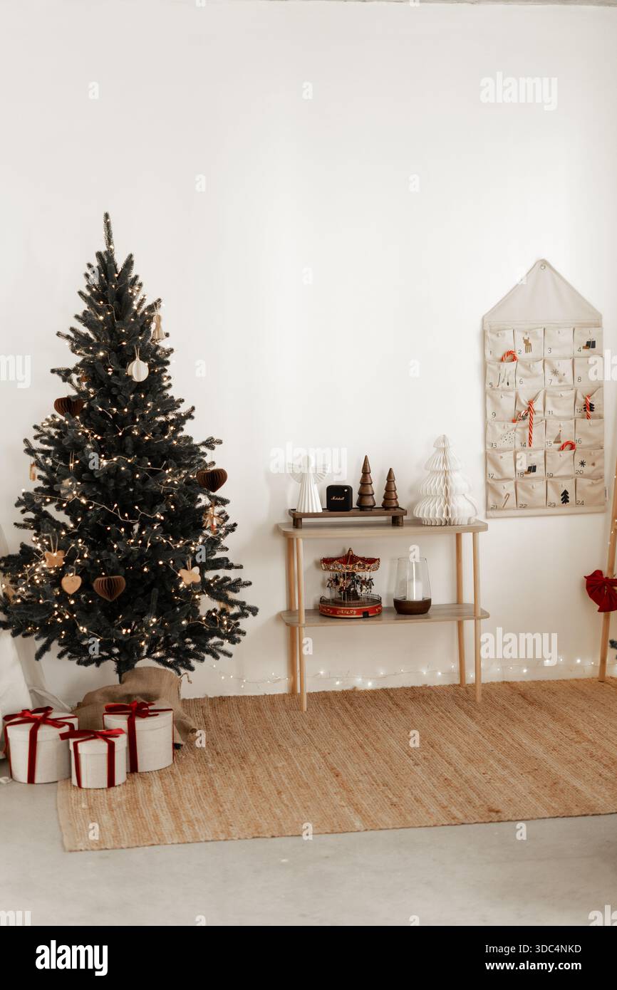 Minimalist Christmas interior with decorated tree fairy lights gift ...