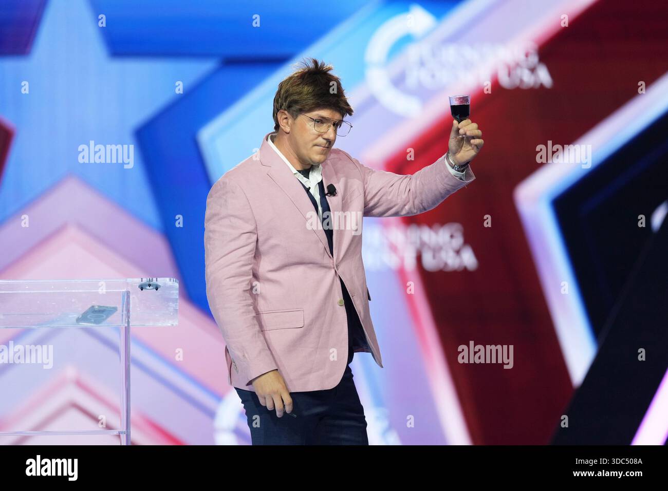 James O'Keefe holds a drink as he speaks during Turning Point USA's ...
