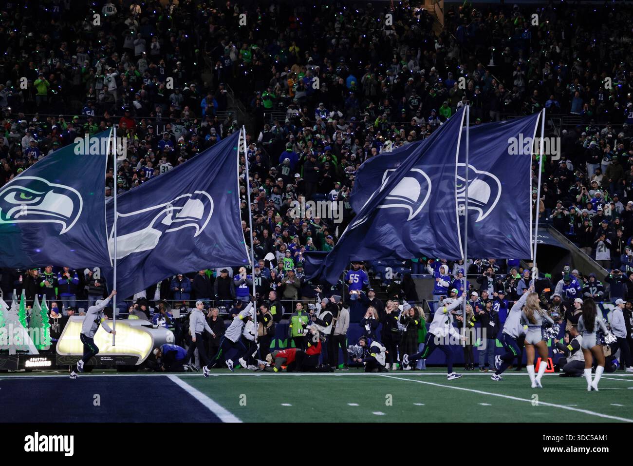 Flags with the Seattle Seahawks logo are carried to the field during ...
