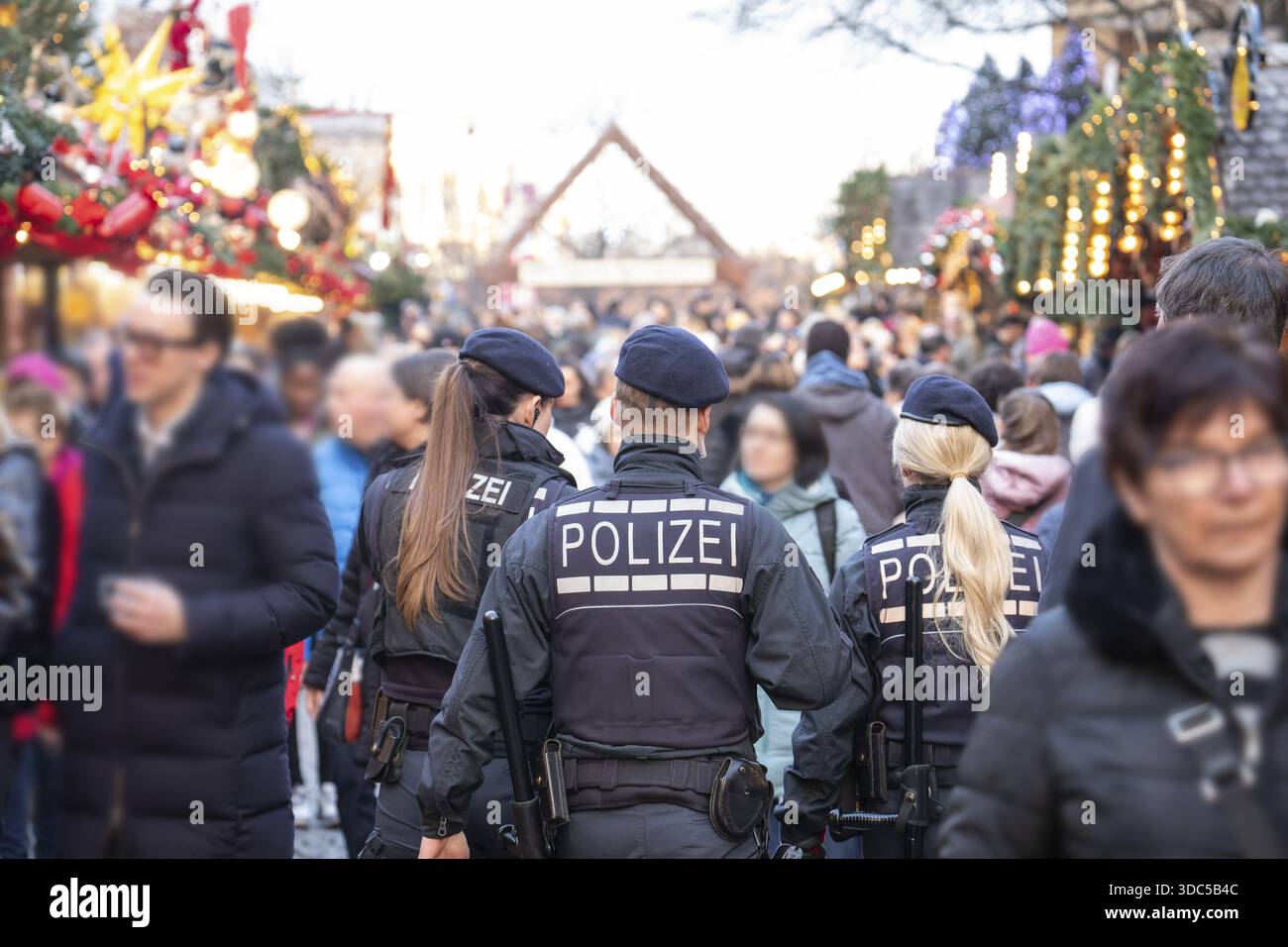 Three police officers are patrolling the Stuttgart 2025 Christmas ...