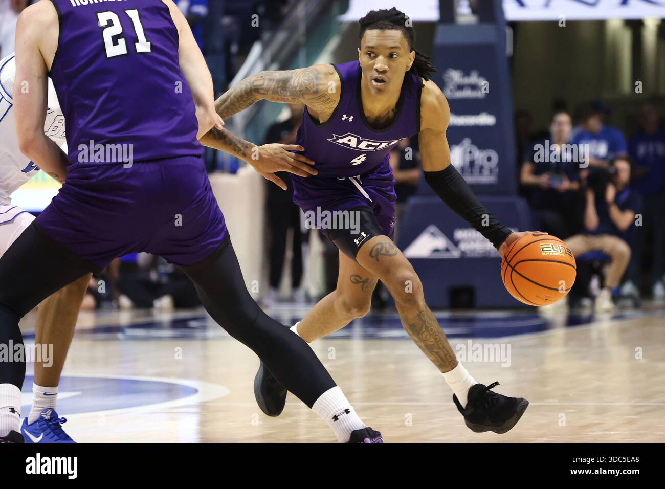 Abilene Christian guard Rich Smith drives on BYU during the first half ...