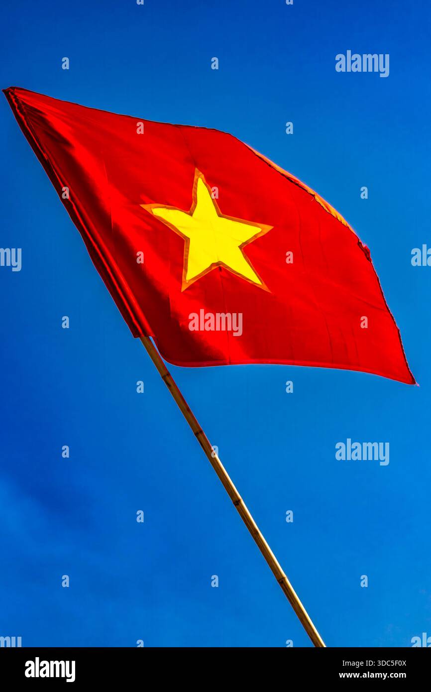 Vietnamese flag flying in front of blue sky, Hanoi, Vietnam Stock Photo ...