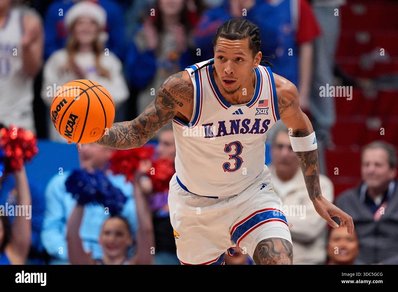 Kansas guard Tre White drives during the first half of an NCAA college ...