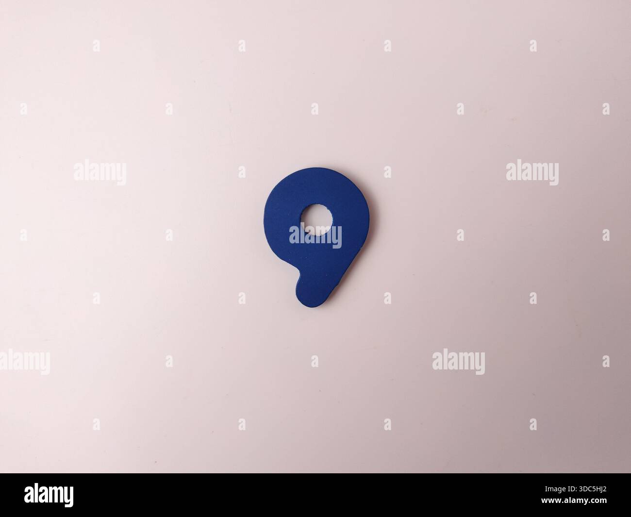 The image shows a dark blue, stylized number 9 on a white background ...