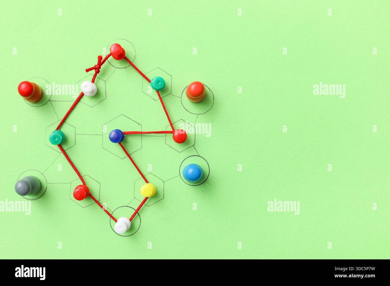 Connected pins with figures and thread on green background. Link ...