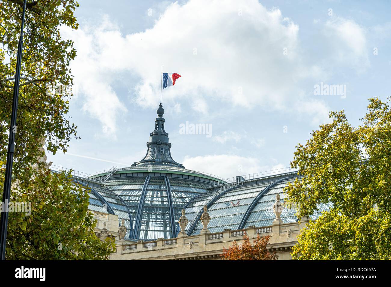 Flag of France in Paris on the glass dome and spire of the Grand Palais ...