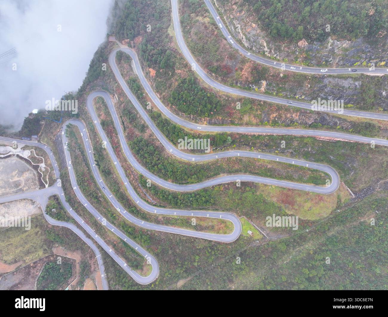DAZHOU, CHINA - DECEMBER 20, 2025 - The winding mountain road in Bashan ...