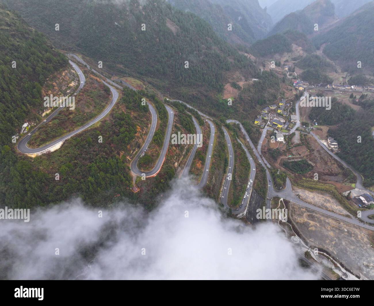 DAZHOU, CHINA - DECEMBER 20, 2025 - The winding mountain road in Bashan ...