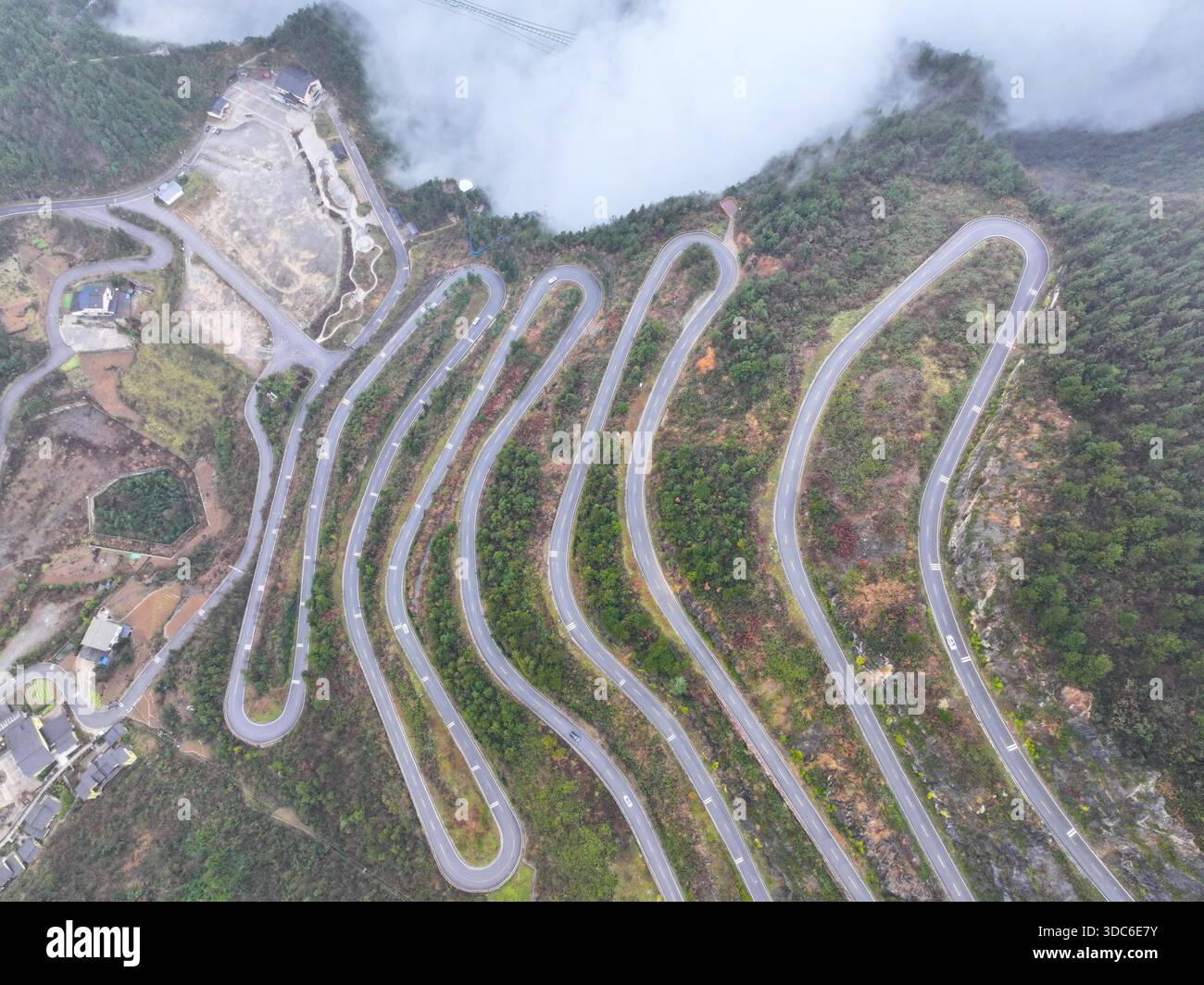 DAZHOU, CHINA - DECEMBER 20, 2025 - The winding mountain road in Bashan ...