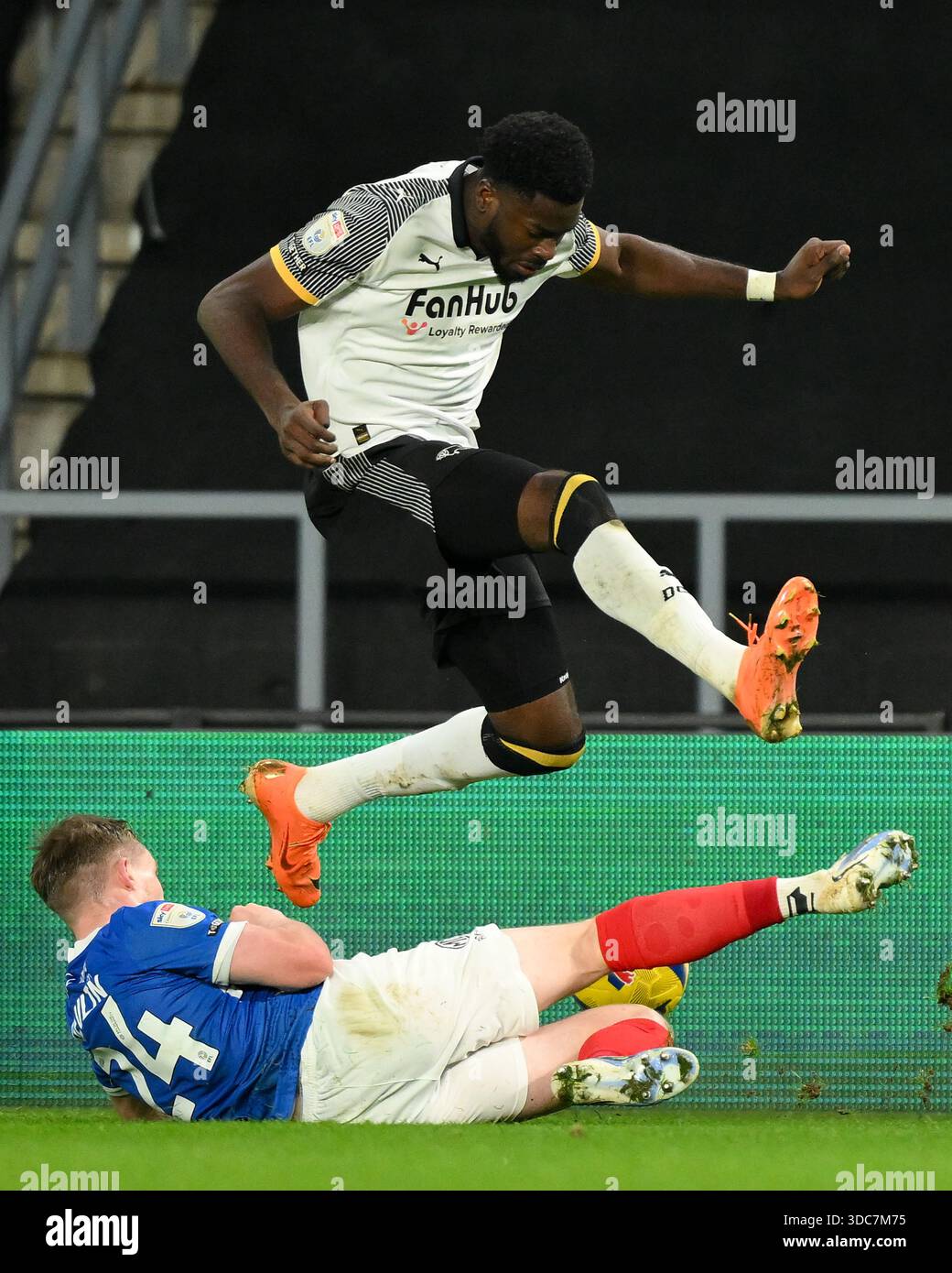 Patrick Agyemang of Derby County jumps over Terry Devlin of Portsmouth during the Sky Bet ...