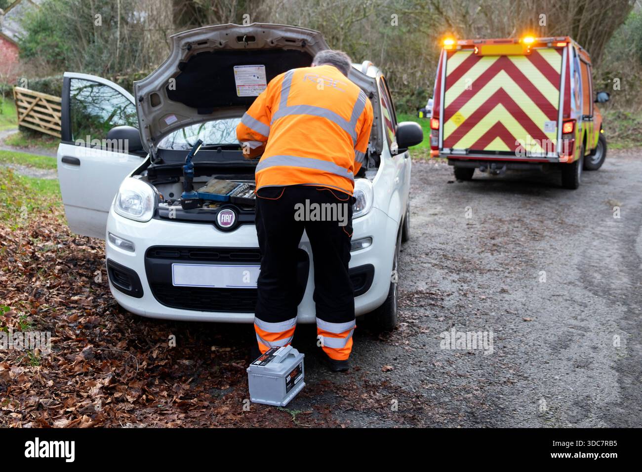 Worker mechanic working on Fiat car engine battery RAC breakdown rescue ...