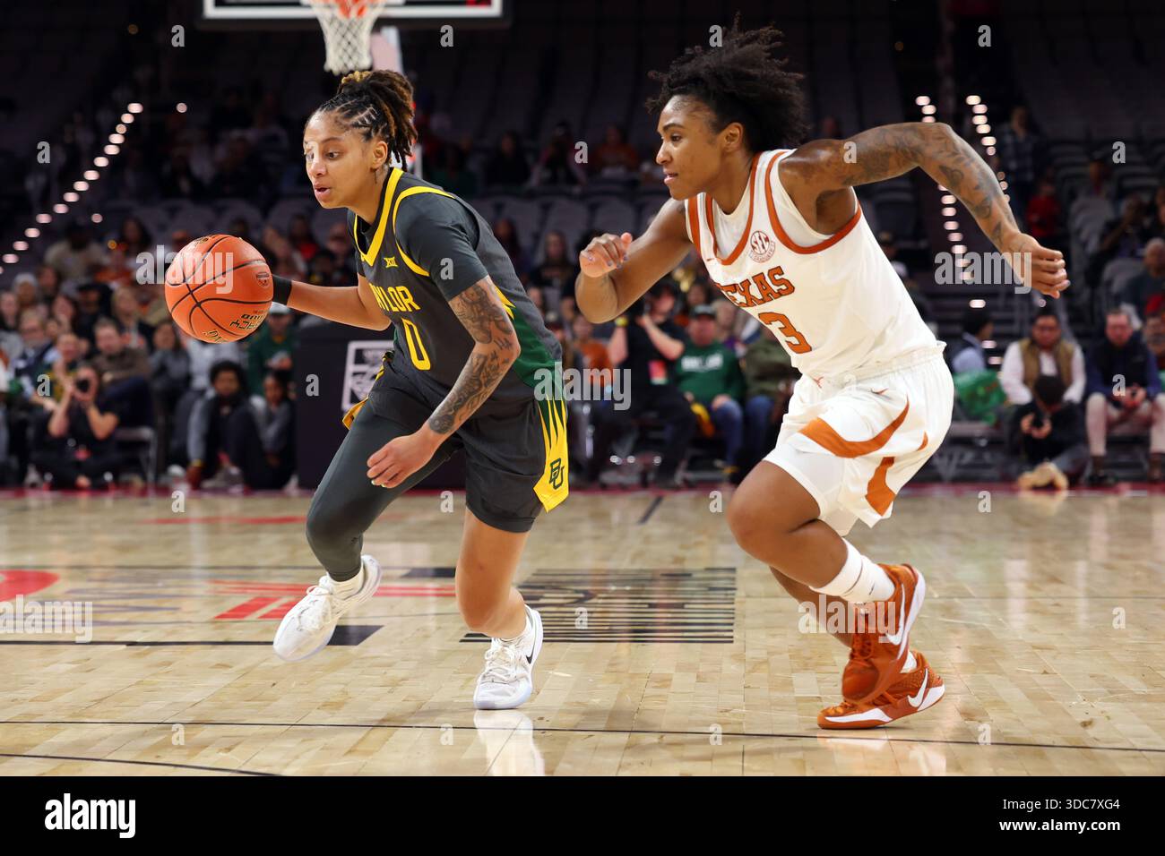 Baylor guard Taliah Scott (0) drives the ball past Texas guard Rori ...