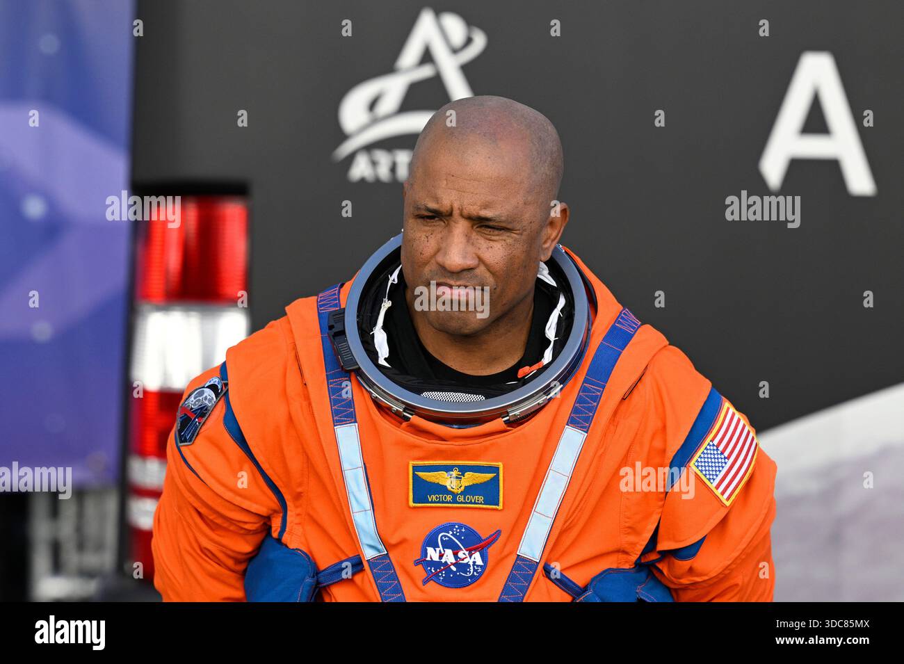 Artemis II pilot Victor Glover stands in front of the crew transport ...