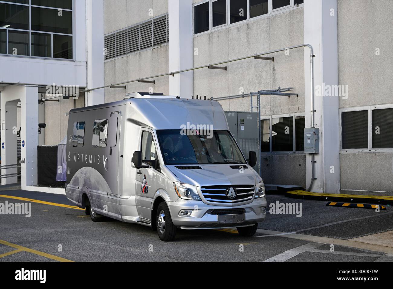 A crew transport vehicle carrying Artemis II astronauts leaves the ...