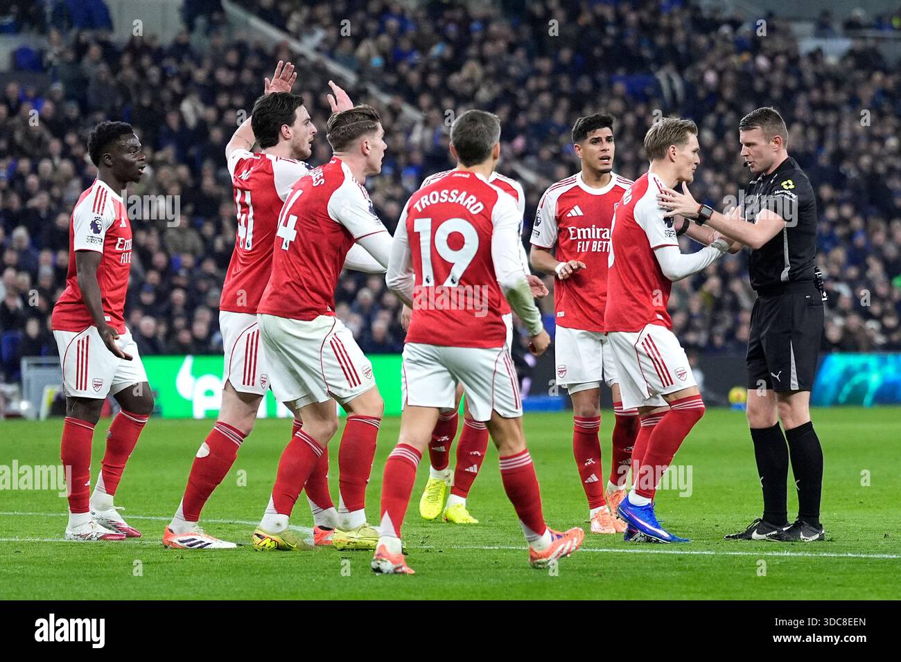 Arsenal players surround referee Sam Barrott during the Premier League ...