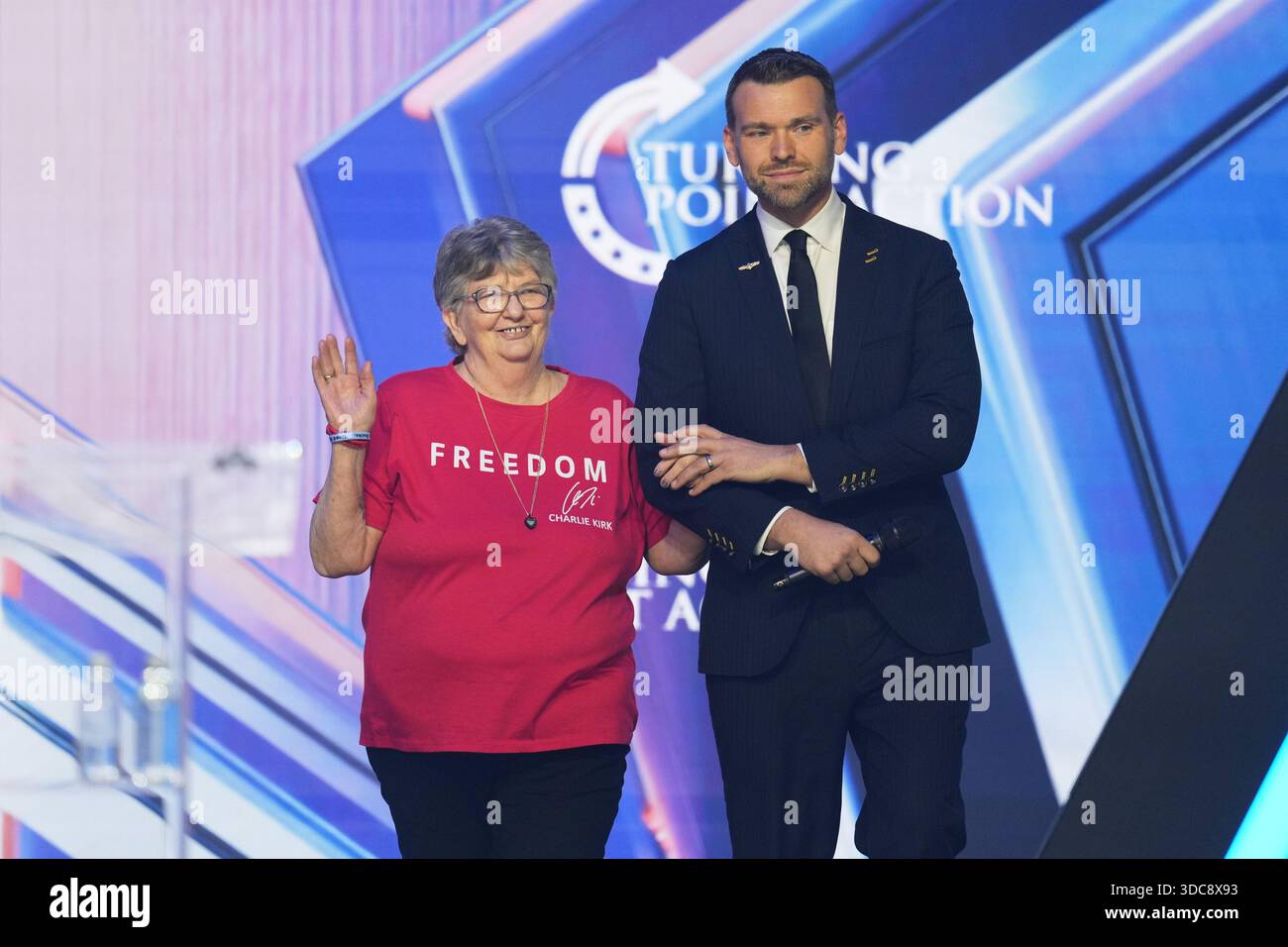 Jeanie Beeman, left, and Jack Posobiec walk on stage during Turning ...