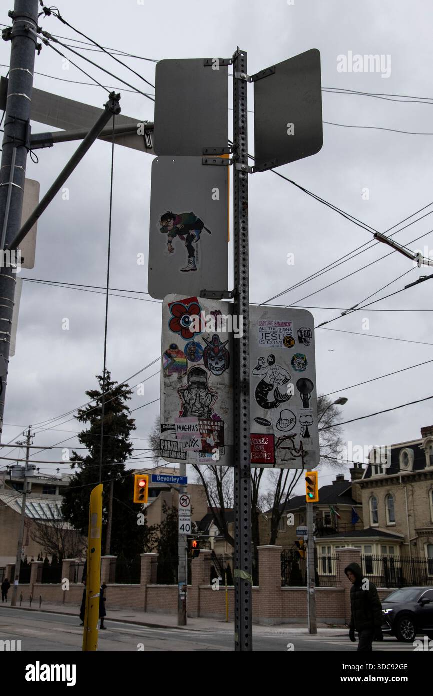 Stickers on street signs on Beverley Street in downtown Toronto ...