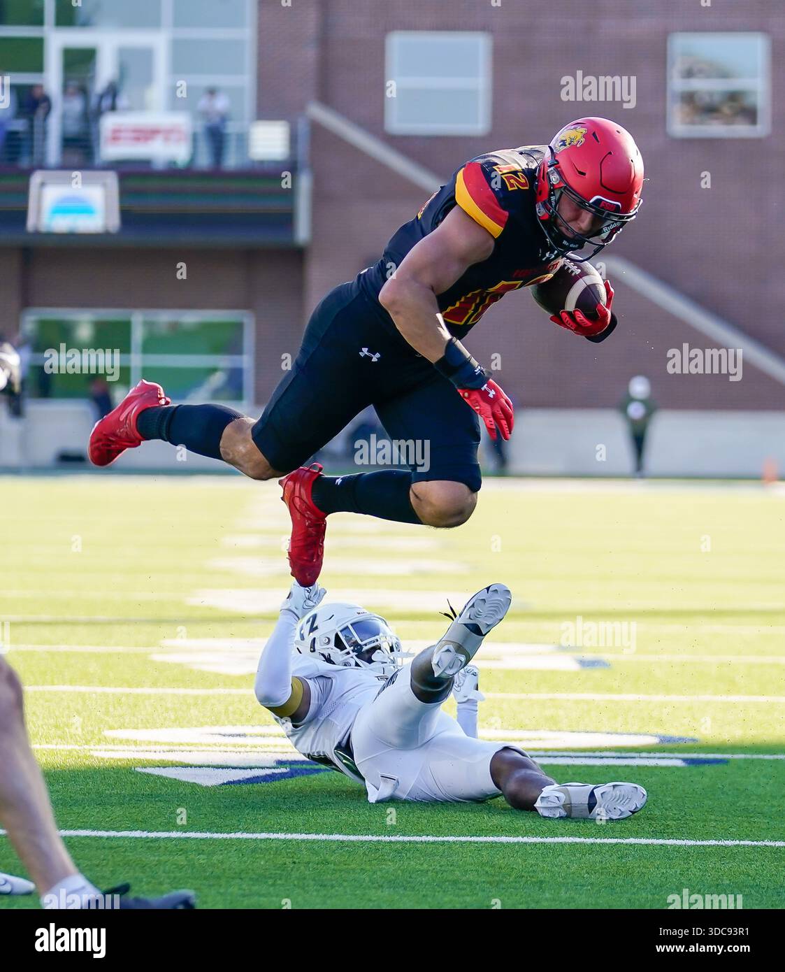 Ferris State Bulldogs Carson Gulker (12) hurdles Harding Bisons ...