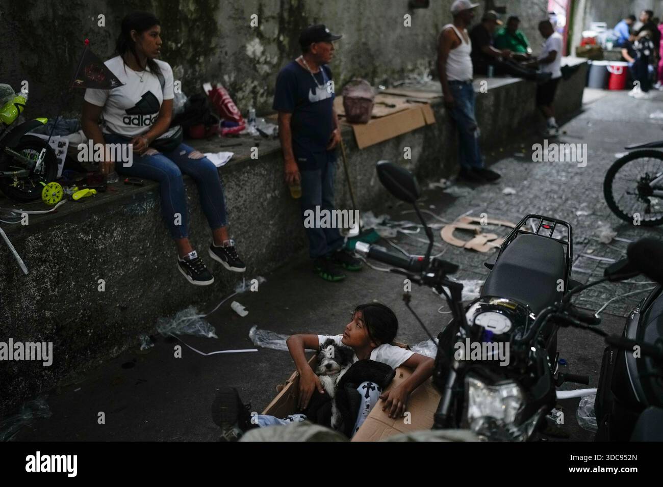 A girl plays with her dog in downtown Caracas, Venezuela, Saturday, Dec ...