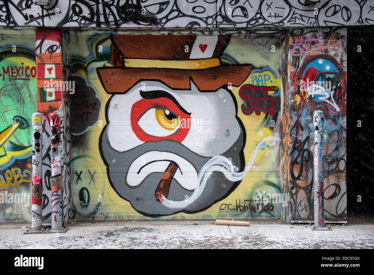 One eyed man smoking a cigar mural on a garage roll up door at Graffiti ...