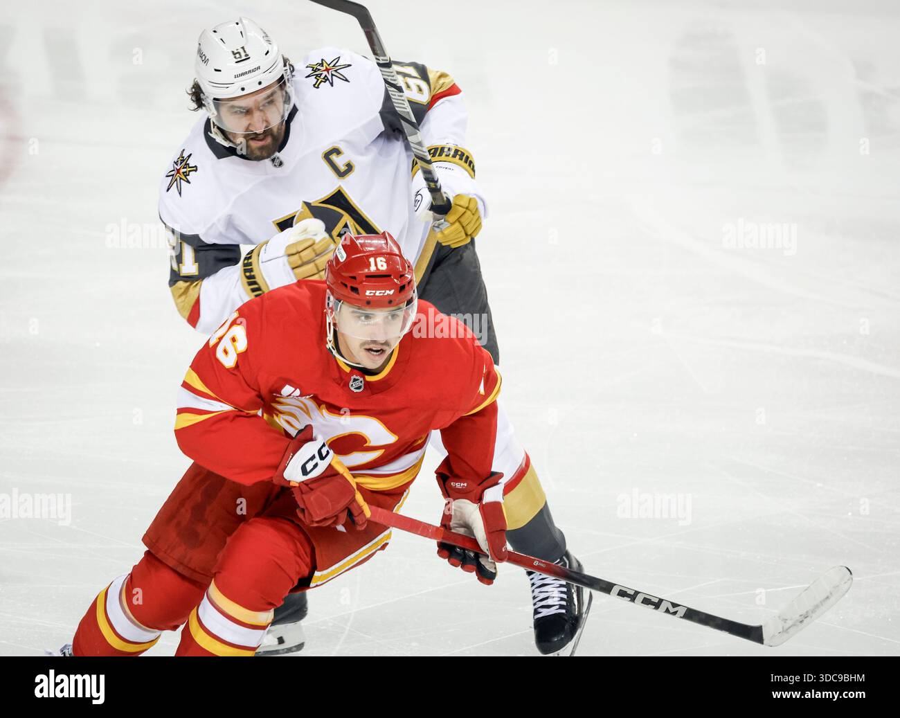 Vegas Golden Knights' Mark Stone, top, checks Calgary Flames' Morgan ...