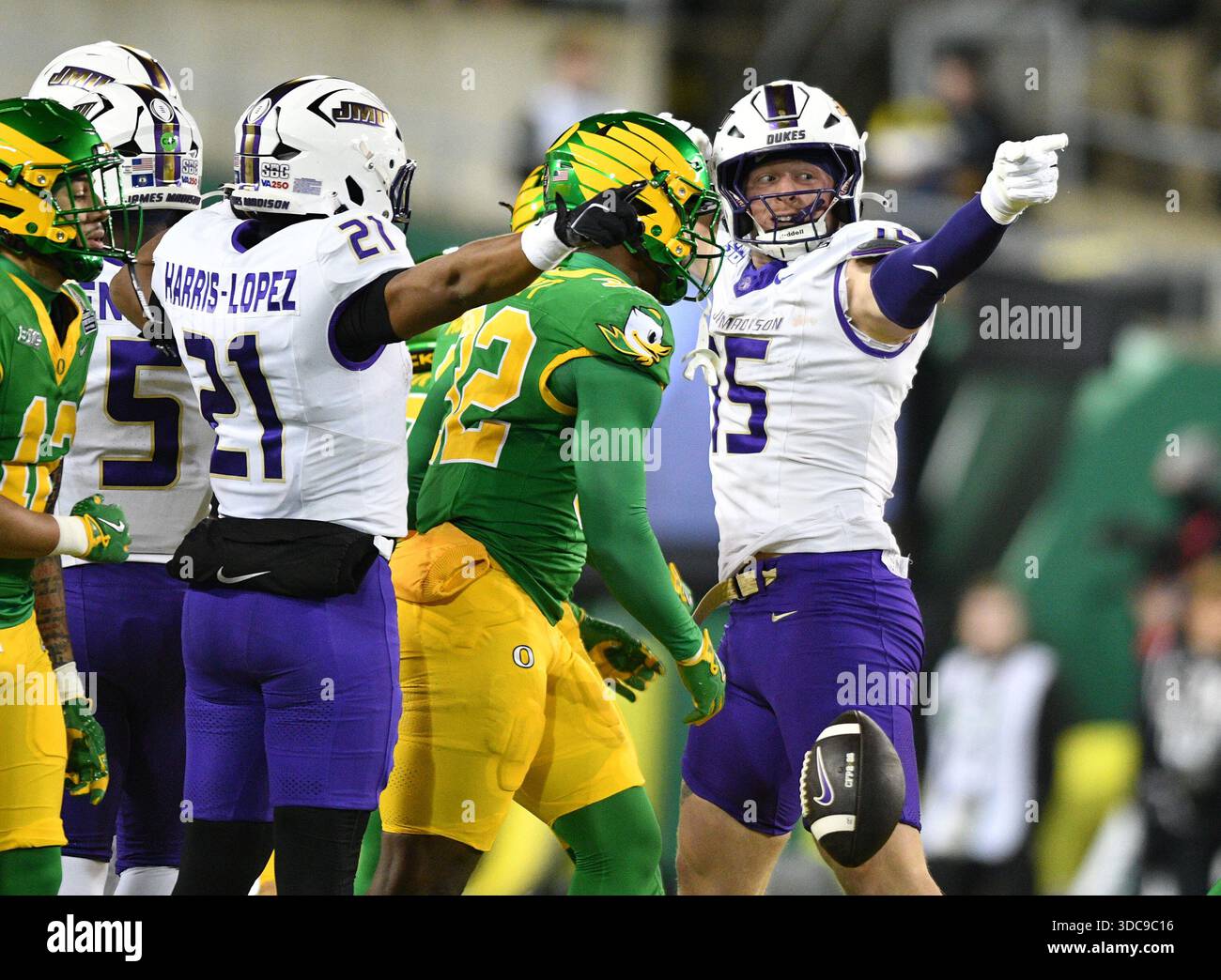 James Madison defensive back Curtis Harris-Lopez (21) and tight end ...