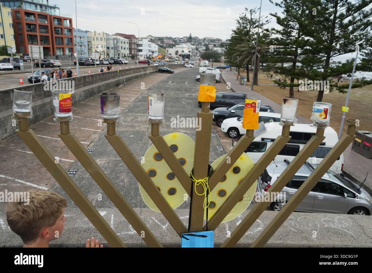 A boy stands near a menorah placed on the bridge at Bondi Beach in ...