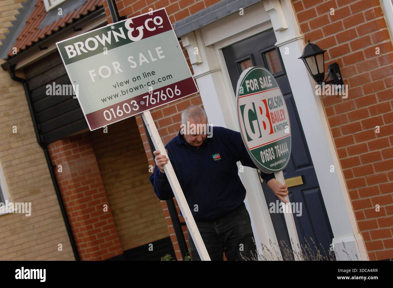 A sign erector puts up for sale and sold signs on behalf of estate ...