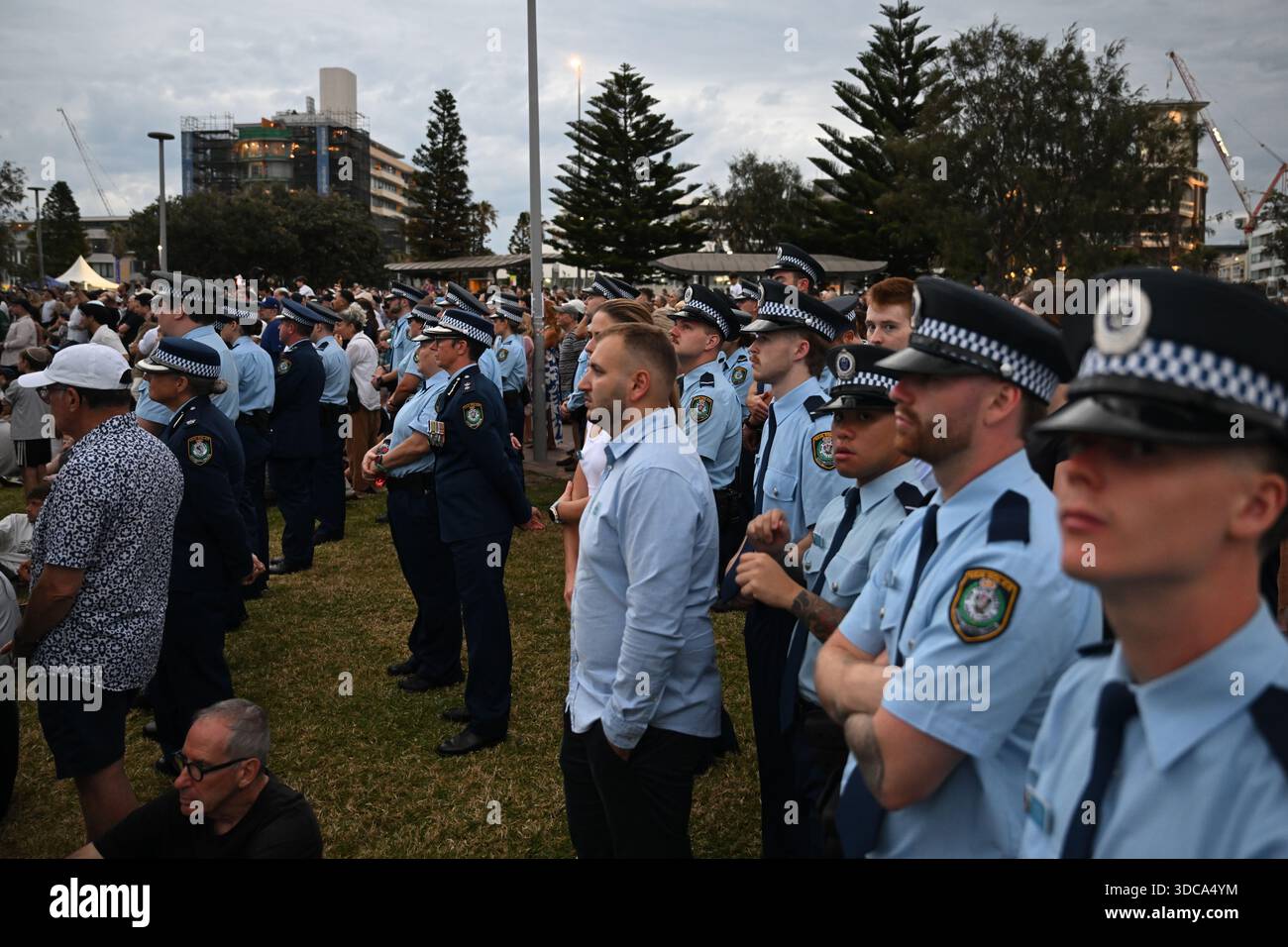 NSW Police officers join a large crowd for a National Day of Reflection vigil and commemoration ...