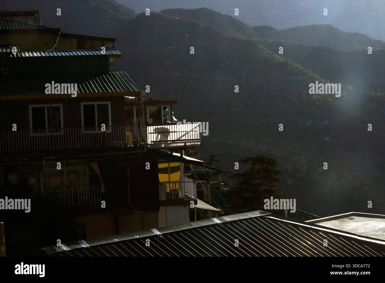 An exiled Tibetan cleans his balcony at Mcleodganj near Dharamshala ...