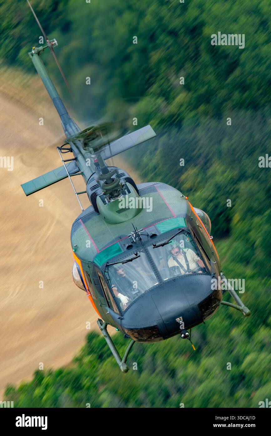Bell UH-1 Iroquois Huey helicopter is shown in air-to-air flight at ...