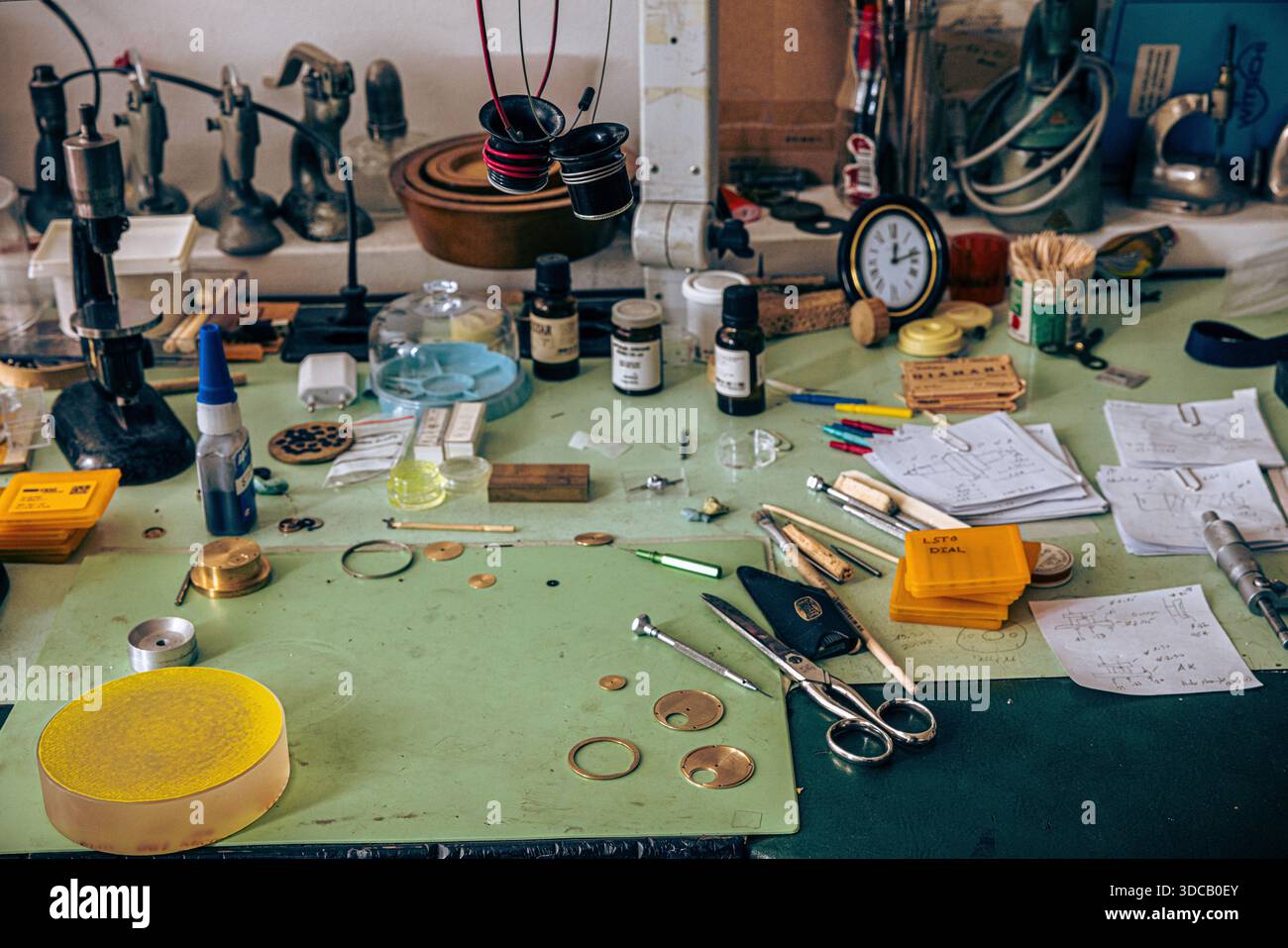 Workbench full of various specialised tools of the watchmaking trade ...