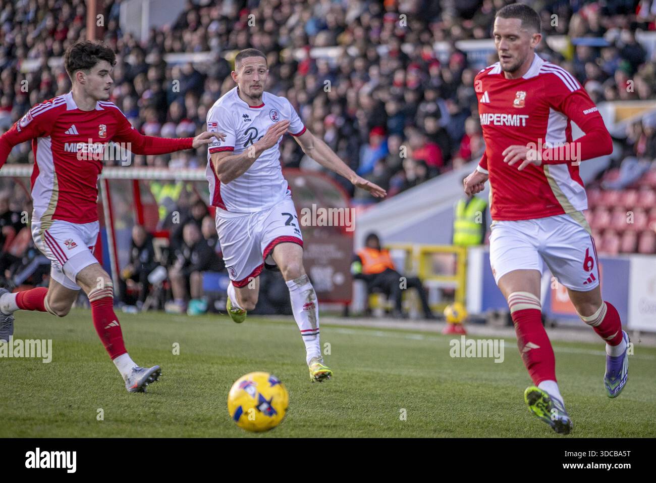 Knight Lebel(L) and James Ball (R) of Swindon and Ryan Loft (C) of ...