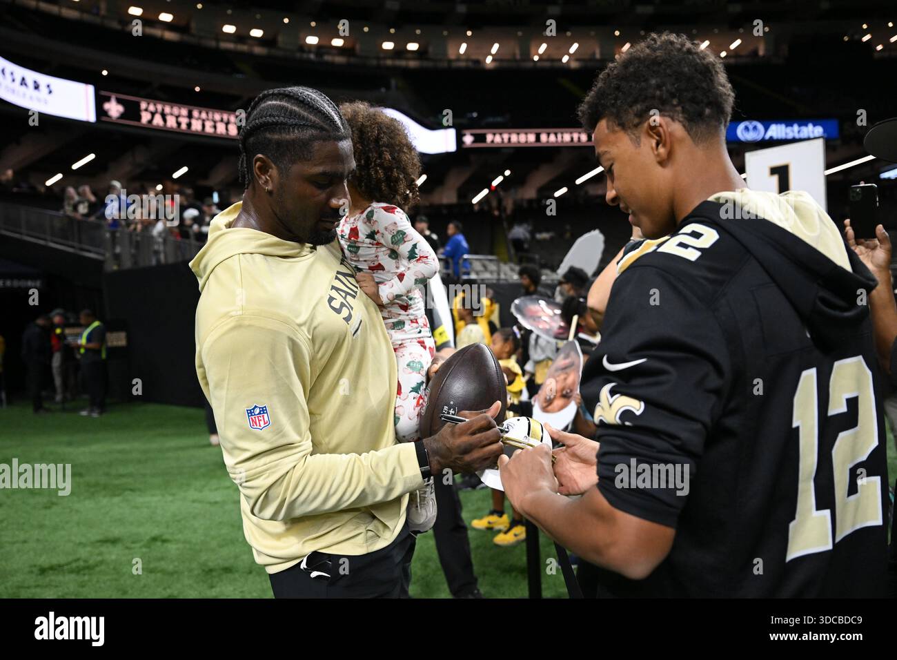 New Orleans Saints tight end Juwan Johnson signs autographs before an ...